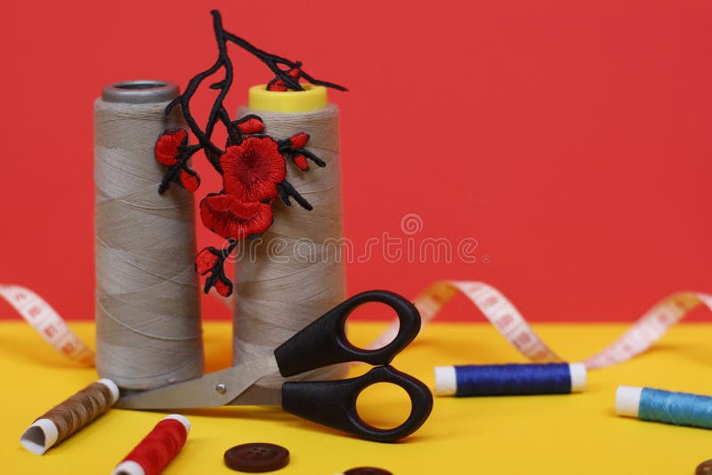 Two Large Spools of Thread are Standing, Many Small Spools are Lying ...