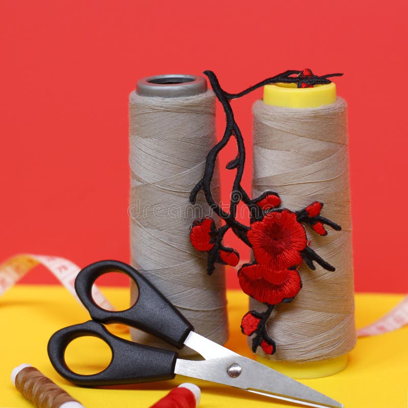 Two Large Spools of Thread are Standing, Many Small Spools are Lying ...