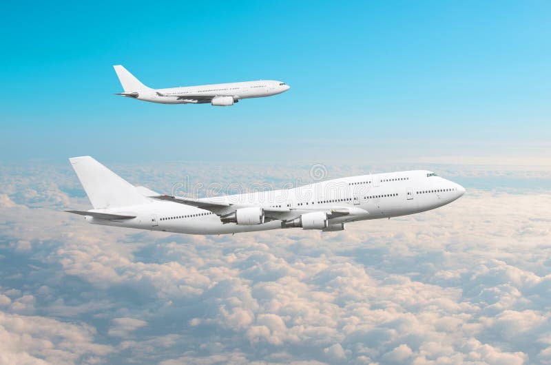 Two Large White Passenger Airplanes Fly Parallel To Each Other in the ...