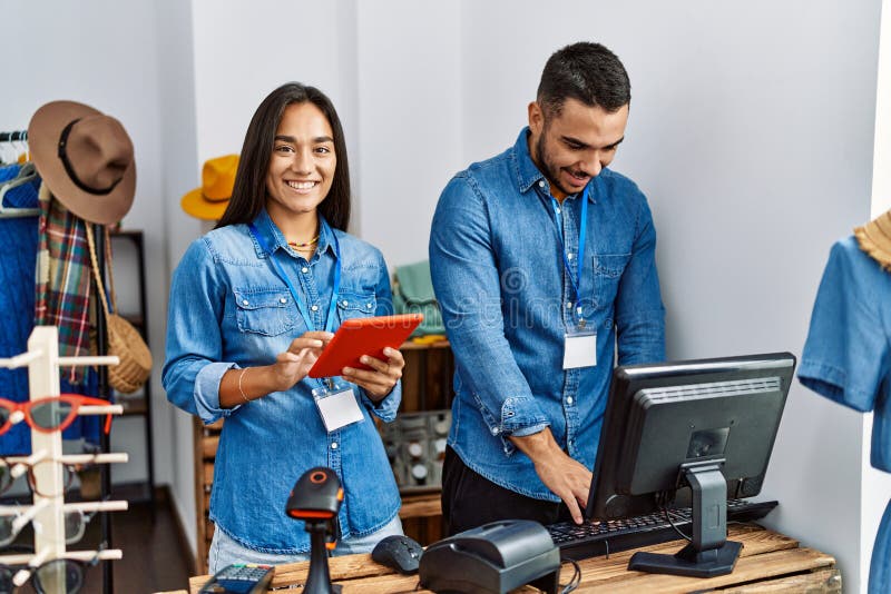 Two Latin Shopkeepers Using Touchpad Working at Clothing Store Stock ...