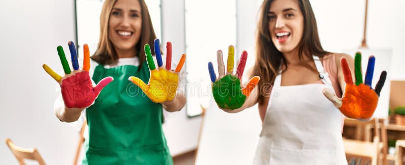 Two Latin Students Smiling Happy Showing Fun Painted Hands at Art ...