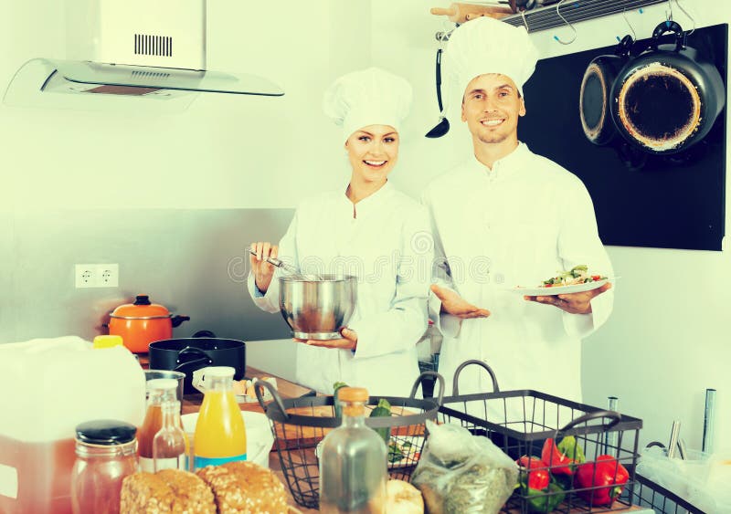Two Laughing Female and Male Cooks Stock Image - Image of counter ...
