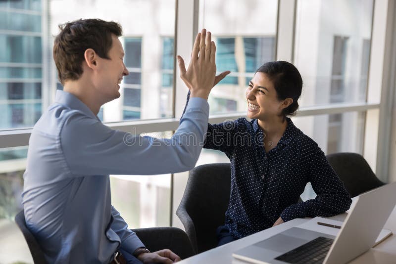 Two Laughing Multiethnic Professionals Sharing Enthusiastic High-five ...