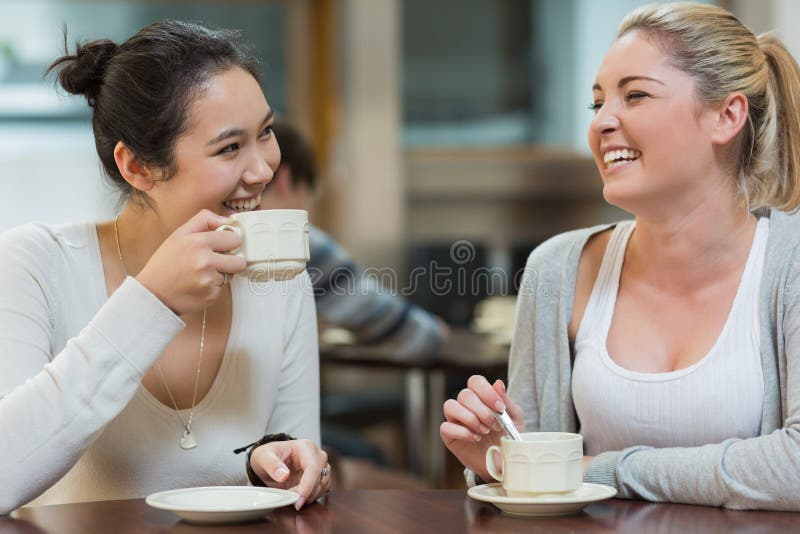Two Laughing Students in College Coffee Shop Stock Photo - Image of ...
