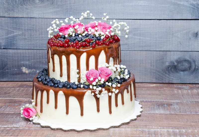 Two Layered Color Drip Wedding Cake with Bilberries, Red Currant Stock ...