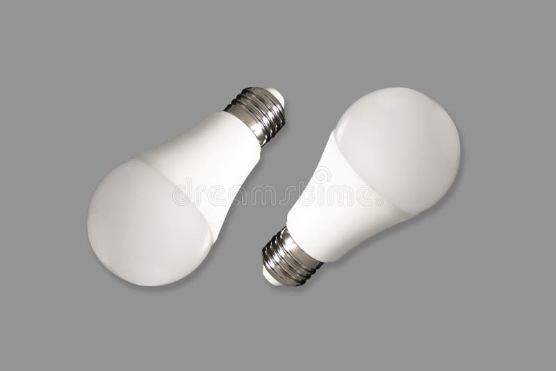 Two Led Bulb Lights and Energy-saving Lamps on Table on Gray Background ...