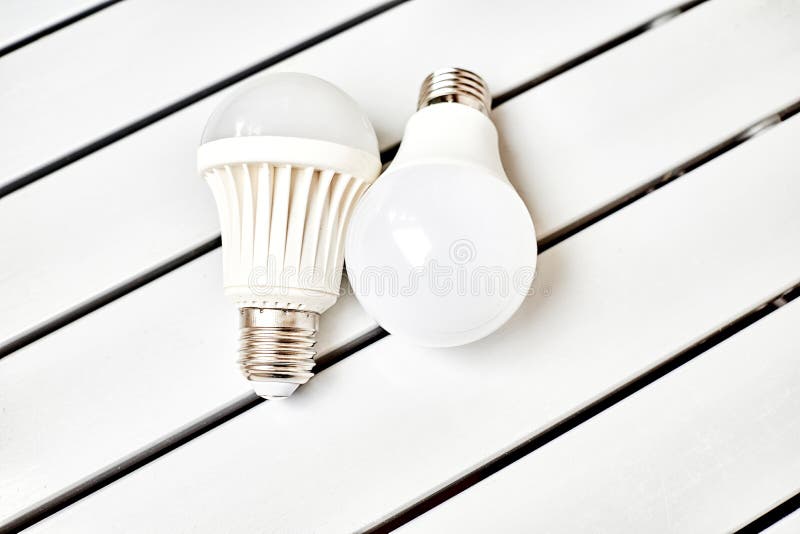 Two LED Bulbs on a Striped Table Stock Image - Image of generation ...