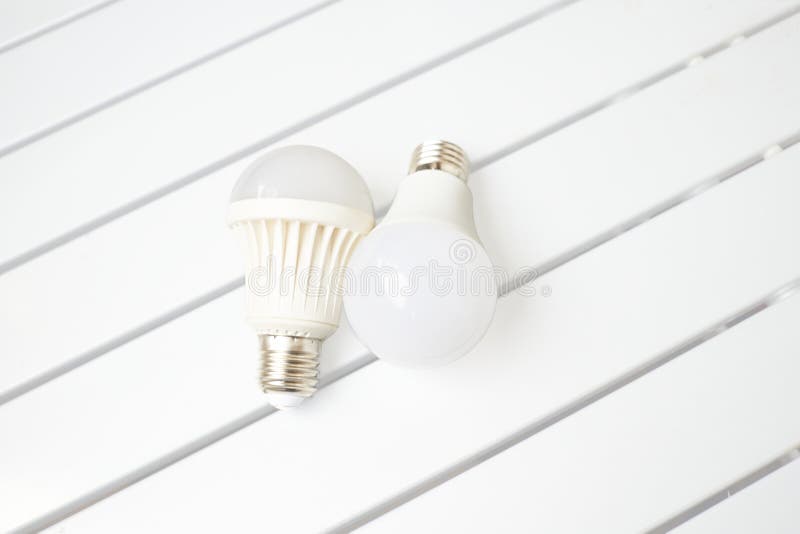 Two LED Bulbs on a Striped Table Stock Photo - Image of electricity ...