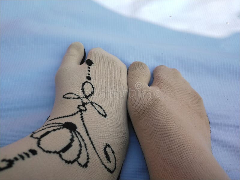 Two Left Feet Wearing Socks. Stock Photo - Image of organ, hand: 322362186