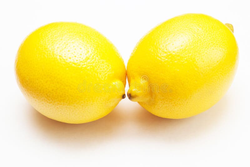 A Cut Lemon In Front Of Two Lemons Stock Photo - Image of vegetables ...
