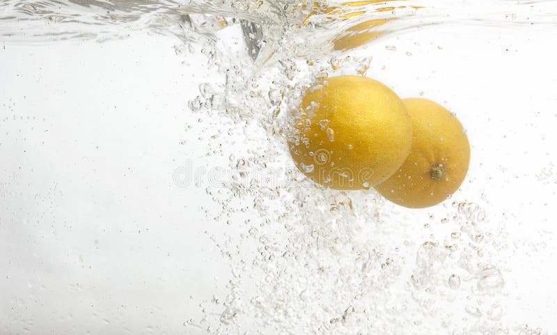 Two lemons in fresh water. stock photo. Image of level - 8066968