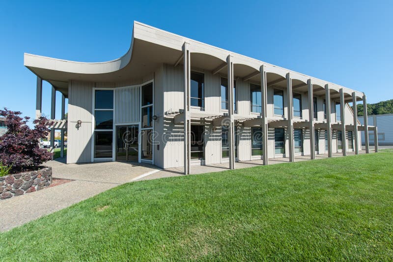 Two Level Office Building with Grass Next To it Stock Image - Image of ...