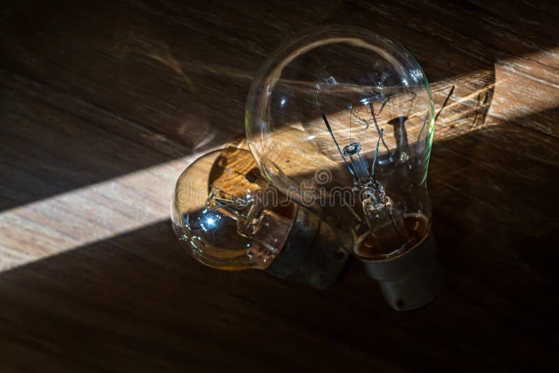 Two Light Bulbs on Wood Texture Background, Light and Shadow, Close Up ...