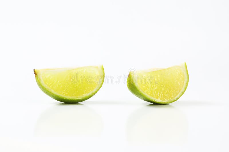 Two lime fruit wedges stock image. Image of pieces, background - 309029323