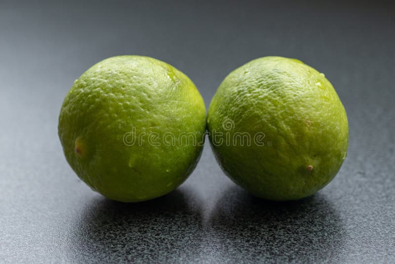 Two Limes with a Dark Background Stock Image - Image of fresh, closeup ...