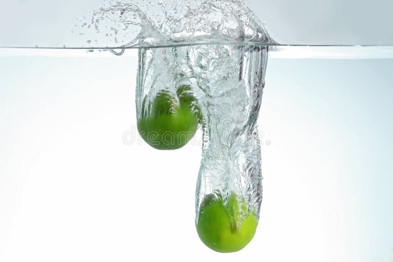Two Limes Dropping in Water Stock Photo - Image of ripe, splashing ...