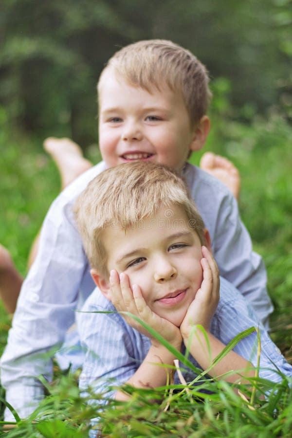 Two Litle Brothers Relaxing on a Grass Stock Image - Image of male ...