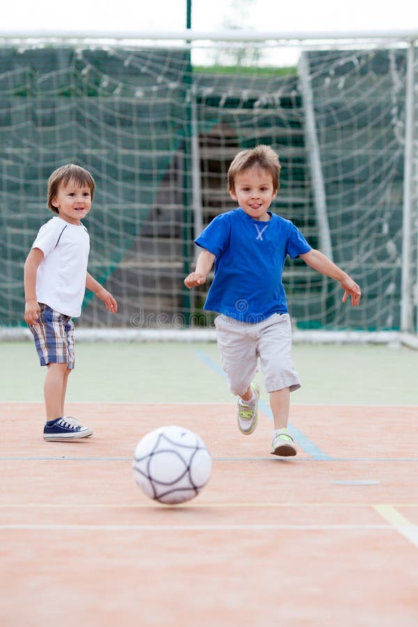 Two Little Boy, Playing Football Stock Image - Image of ball, siblings ...