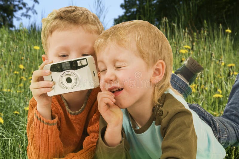 Two Little Boys With Camera Stock Photo - Image of lying, photographer ...