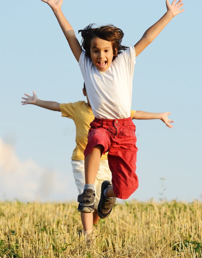 Two Little Boys on Field Running Together Stock Image - Image of space ...