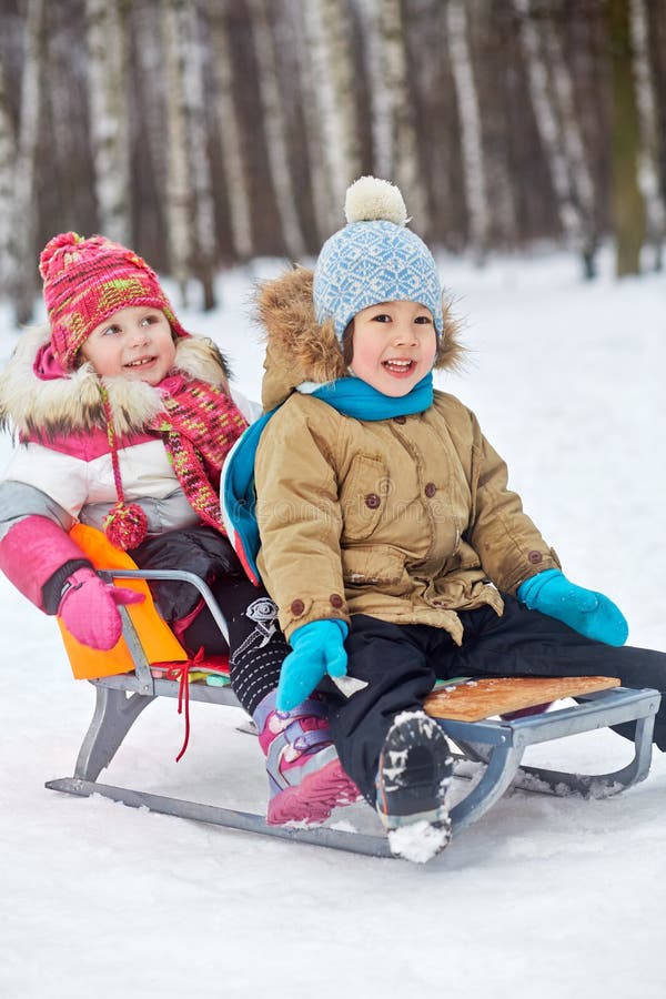 Two Little Children Sit in Sledge Stock Photo - Image of knitted, child ...