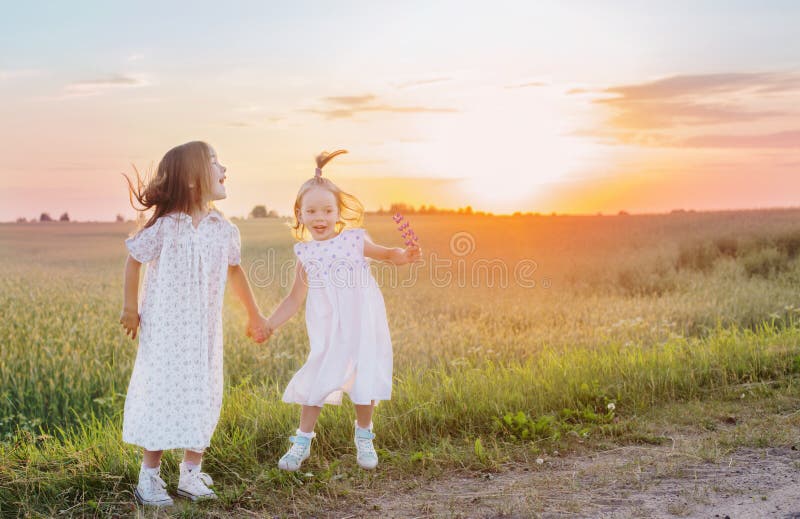 Little Girl Jumping in Field at Sunset Stock Photo - Image of meadow ...