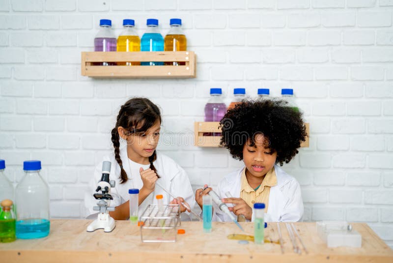 Two Little Girl Look Fun after Make Spread of Chemical Liquid on Table ...