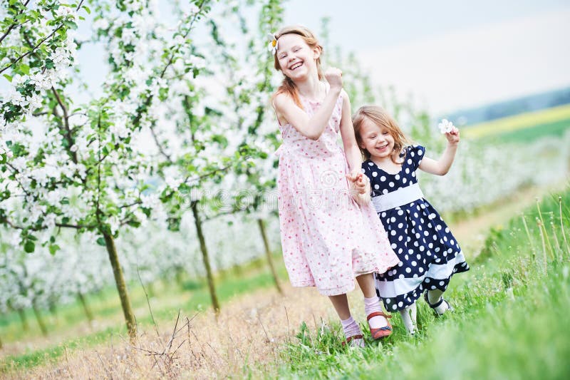 Two Little Girl Run and Having Fun in Spring Garden Stock Photo - Image ...