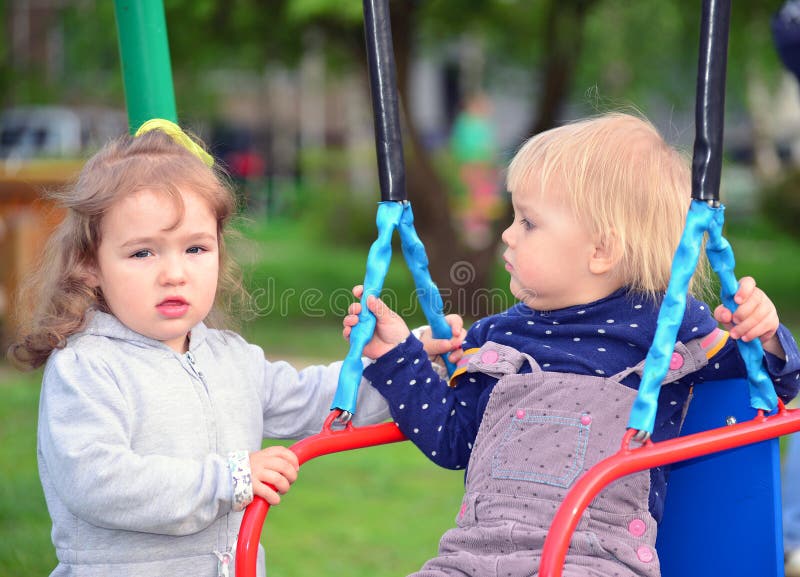 Two Little Girl on Swing Ride Stock Image - Image of freedom, garden ...