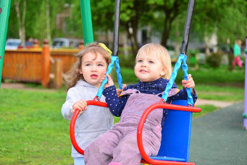 Two Little Girl on Swing Ride Stock Image - Image of freedom, garden ...