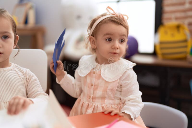 Two Little Girls Drawing on Notebook Sitting on Table at Kindergarten ...