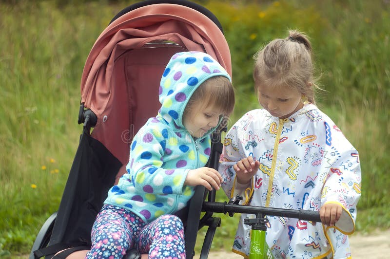 Two Little Girls on a Forest Road Stock Photo - Image of little, sister ...