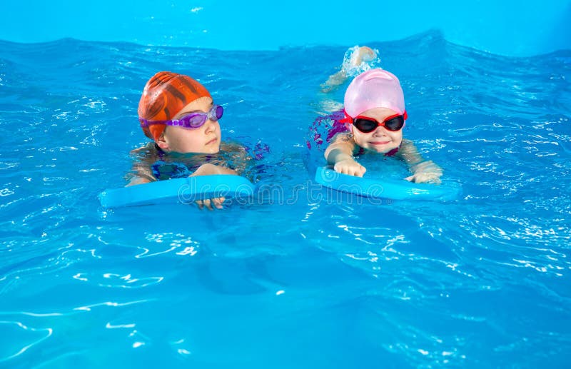 Two Little Girls Learning How To Swim in Swimming Pool Using Flutter ...