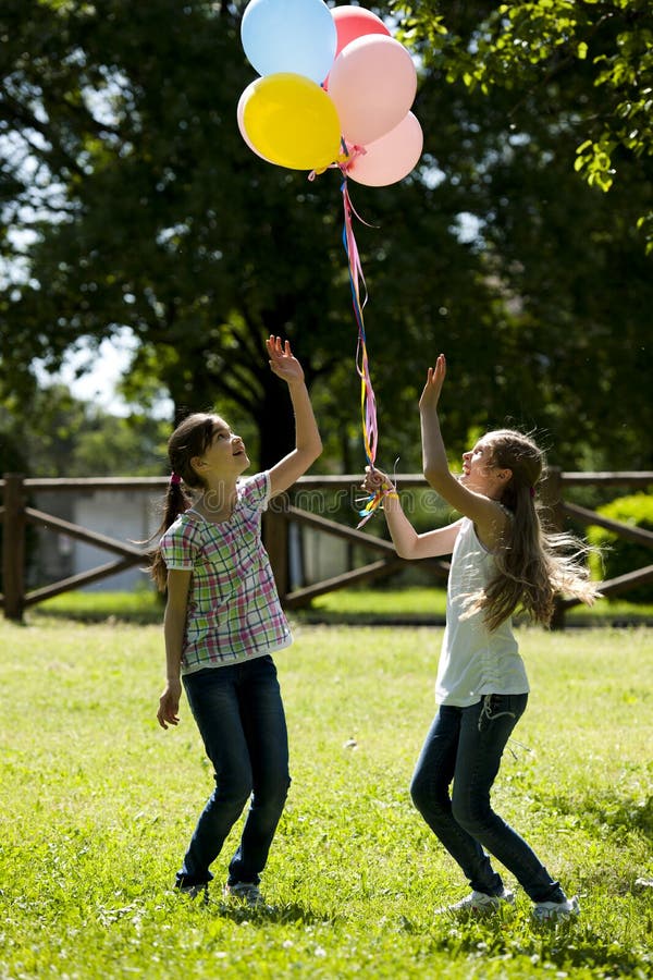 Two Girls Playing Outdoors Balloons Stock Photos - Free & Royalty-Free ...