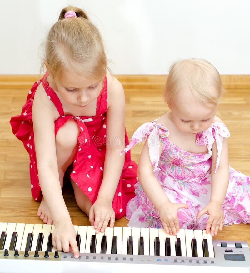 Children playing the piano stock image. Image of contact - 30046249