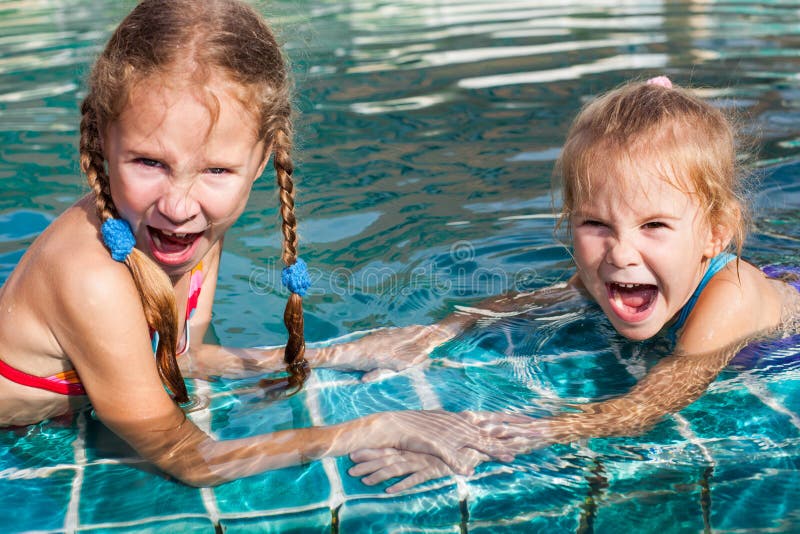 Two Little Girls Playing in the Pool Stock Photo - Image of activity ...