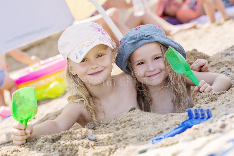 Two Little Girls Playing in the Sand Stock Image - Image of beautiful ...