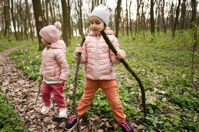 Two Little Girls Playing with Sticks in Spring Forest Stock Photo ...