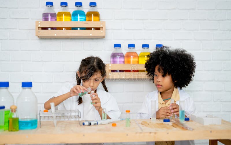 Two Little Girls Practice in Science Class with Different Laboratory ...