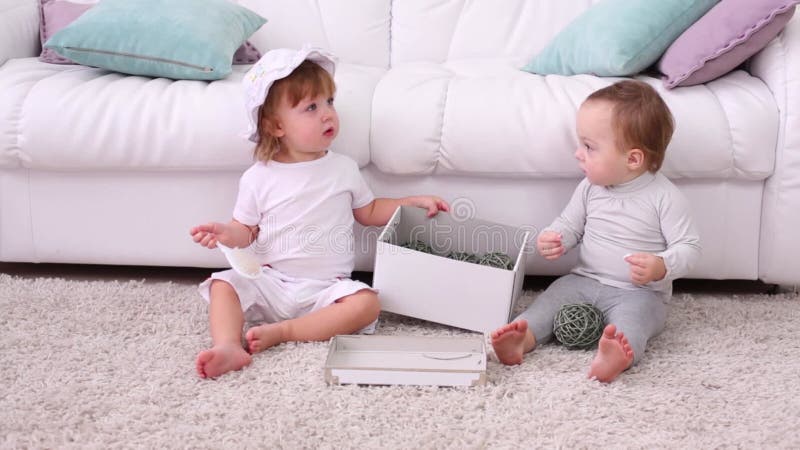 Two Little Girls Sit on Carpet and Play with White Stock Video - Video ...