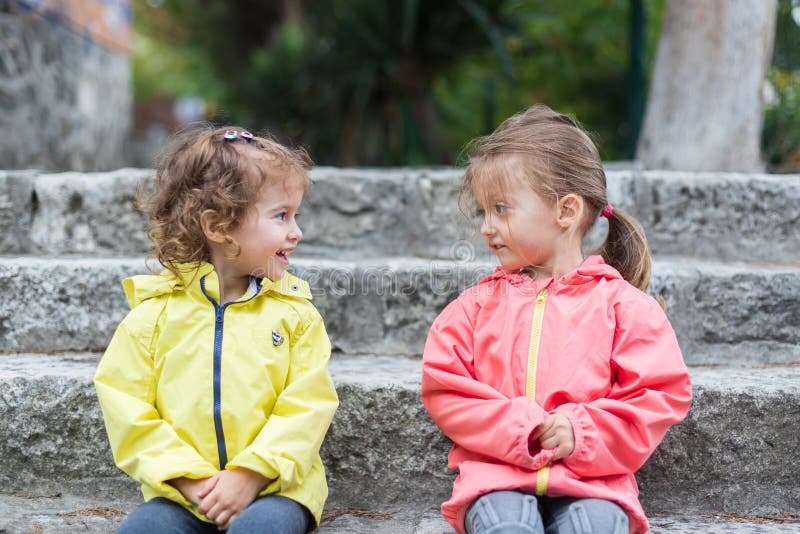 Two Little Girls Sitting on the Stairs, Outside. Happy Childhood Stock ... Two Little Girls Sitting on the Stairs, Outside. Happy Childhood Stock ...