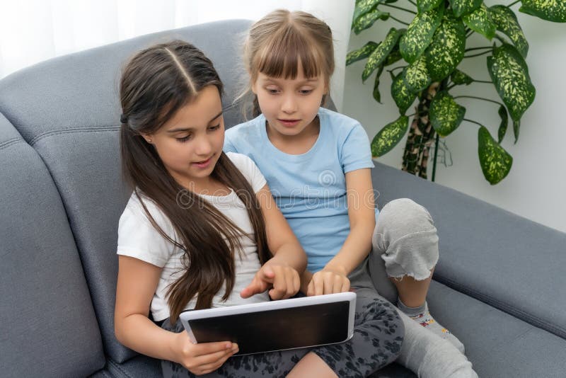 Two Little Girls with a Tablet Stock Image - Image of childhood, happy ...