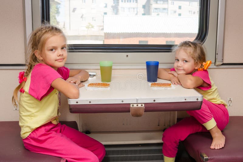 Two Little Girls on Train Sitting at the Table in the Outboard Second ...
