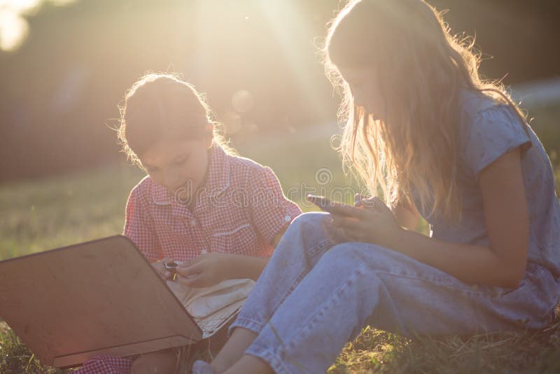 Two Little Girls Using Technology in Nature Stock Image - Image of ...