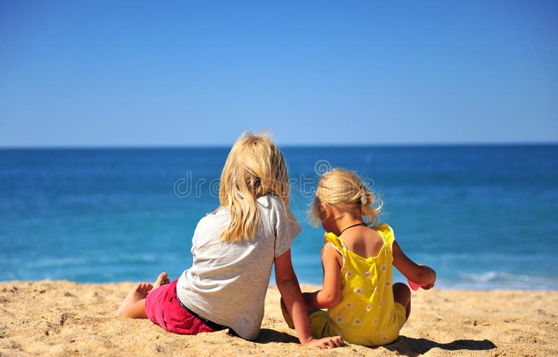 Two Little Kids Playing on the Sand Beach Stock Image - Image of sand ...