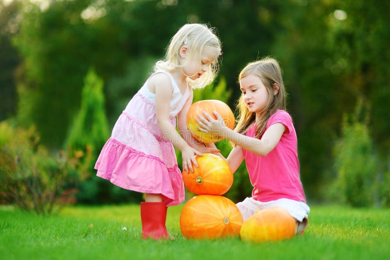 Two Little Sisters Playing Huge Pumpkins Stock Photos - Free & Royalty-Free Stock Photos from ...