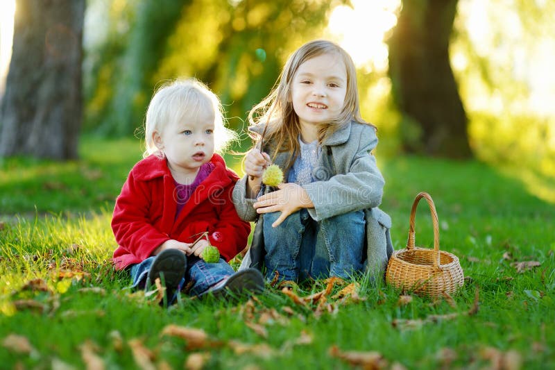 Two Little Sisters Playing Outside Stock Image - Image of alley, jacket ...