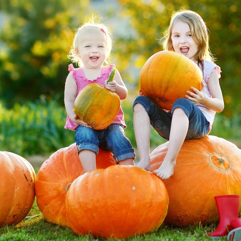 Two Little Sisters Sitting on Huge Pumpkins Stock Image - Image of ...