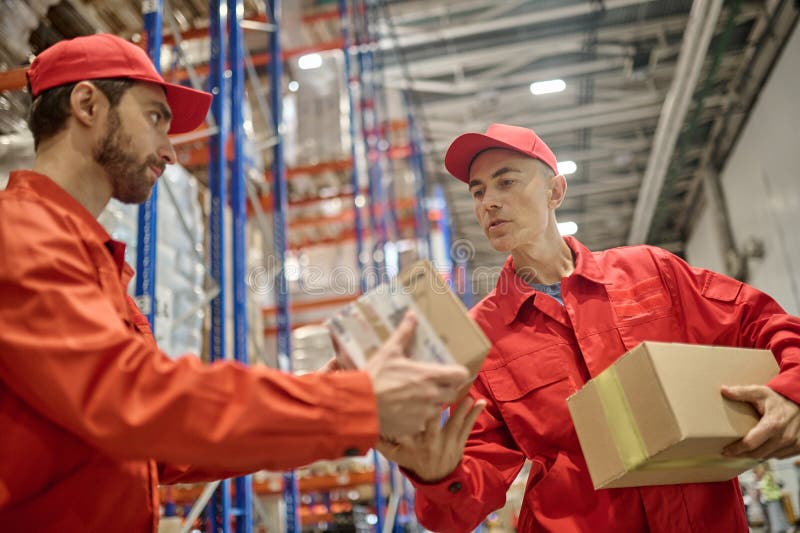 Two Loaders Working Together in the Warehouse Stock Photo - Image of ...