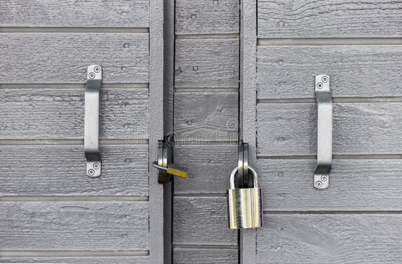 Two Locks on a Wooden Grey Door Stock Photo - Image of close, design ...